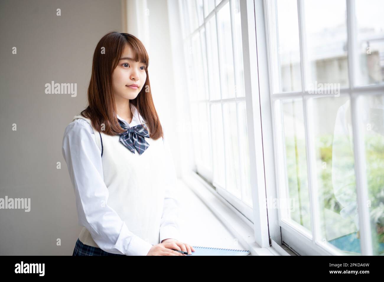 High school girl looking out of window Stock Photo - Alamy