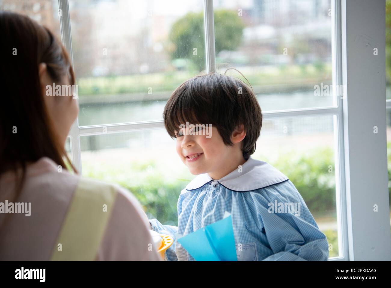 Nursery school teacher and children by the window Stock Photo - Alamy