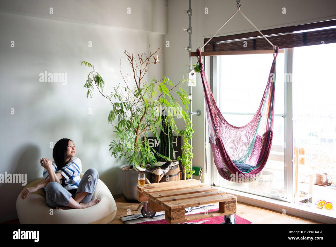 Sitting on cushion hi-res stock photography and images - Alamy