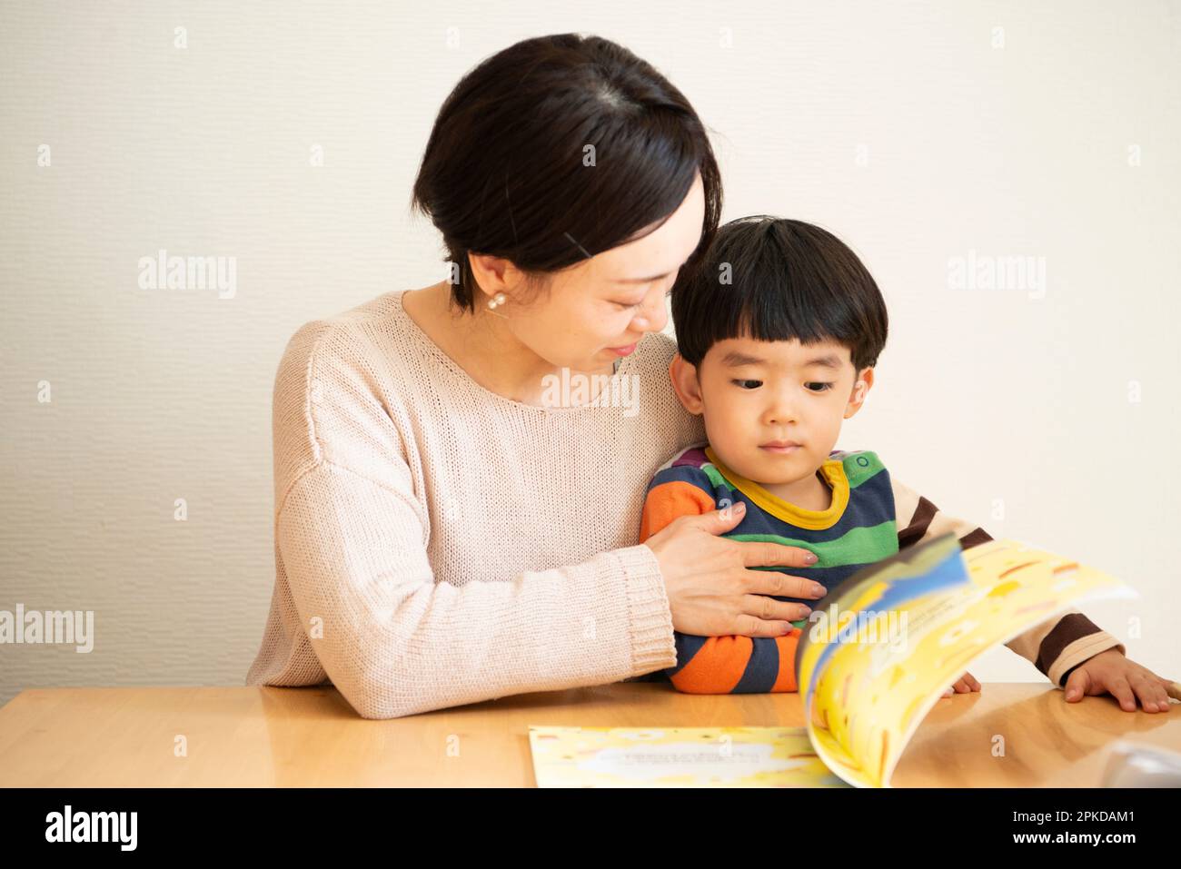 Parent and Child Reading Picture Book Stock Photo - Alamy
