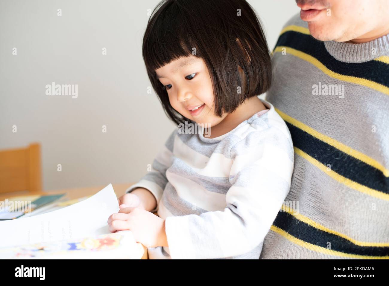 Daughter on fathers lap hi-res stock photography and images - Alamy