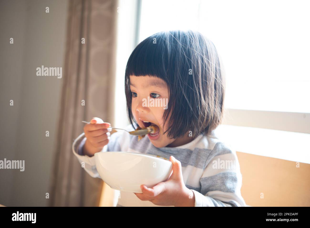 Child eating rice hi-res stock photography and images - Alamy