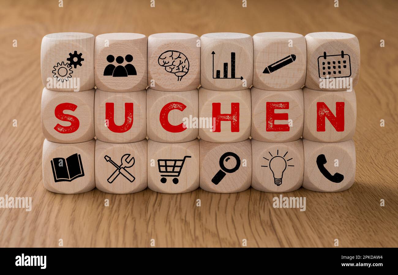 Dice with icons and the word Search in german - Suchen Stock Photo - Alamy