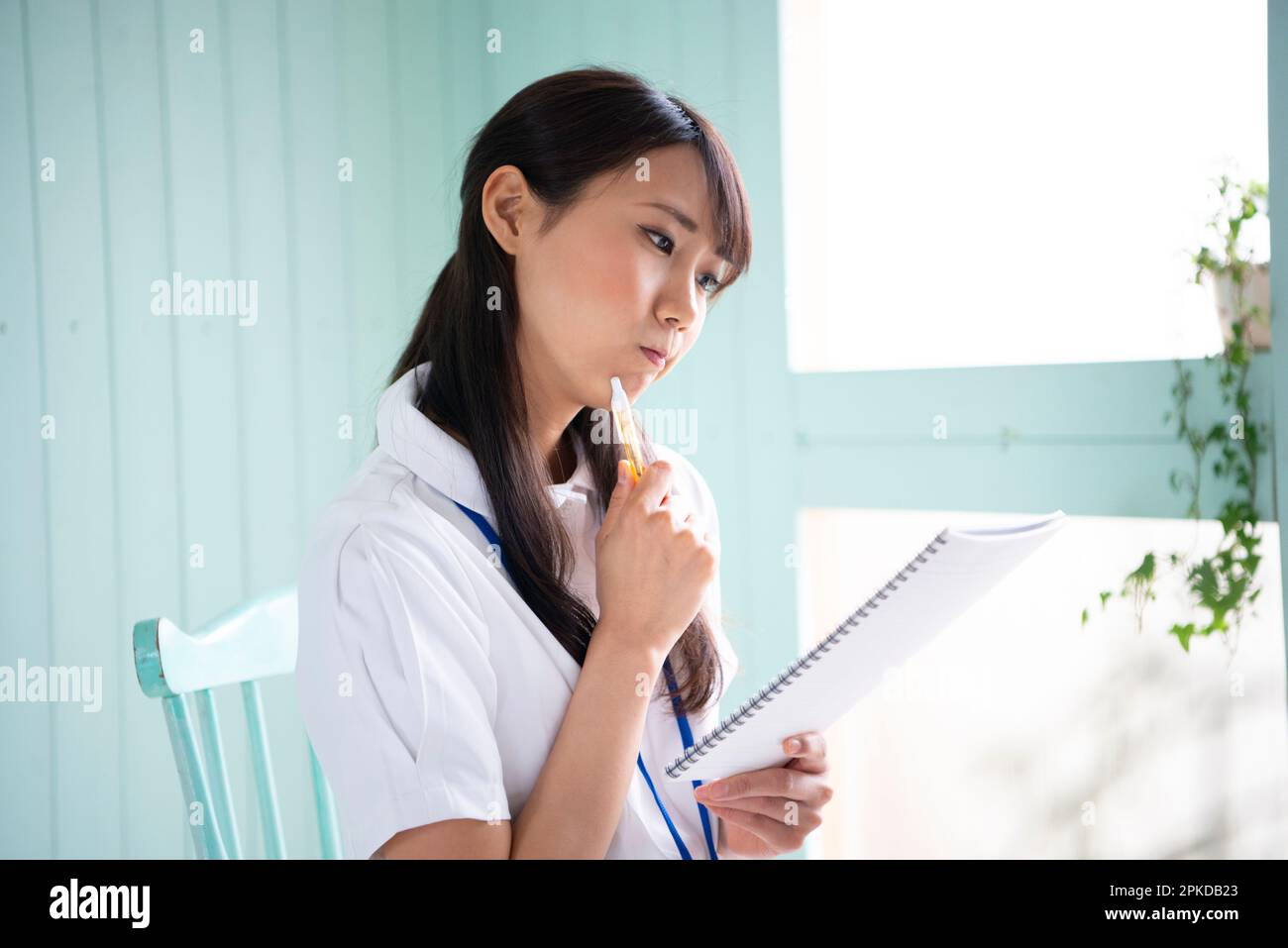 Working woman in uniform looking at a notebook and having trouble Stock ...