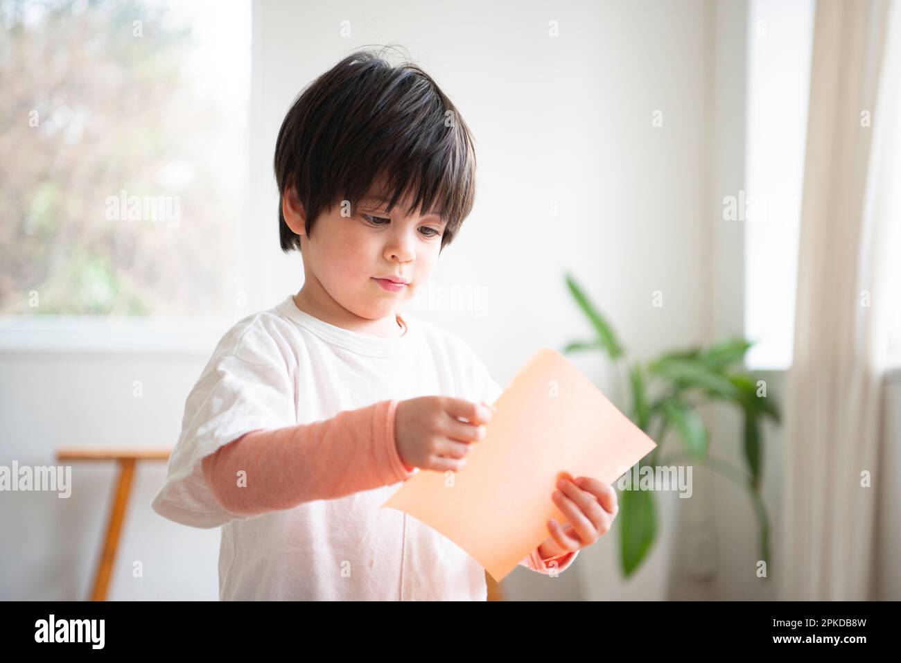 Boy playing with scissors Stock Photo - Alamy