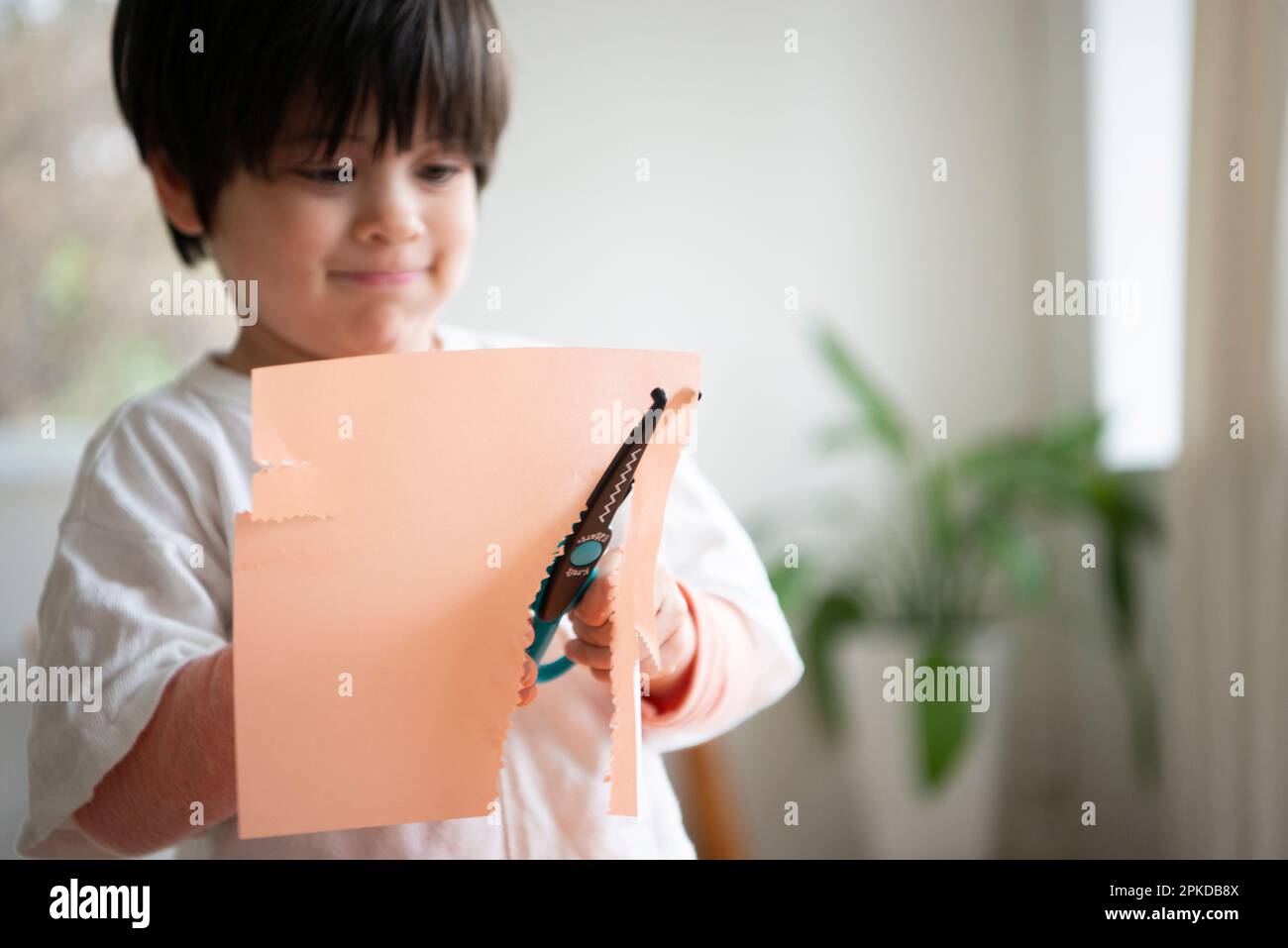 Boy playing with scissors Stock Photo - Alamy