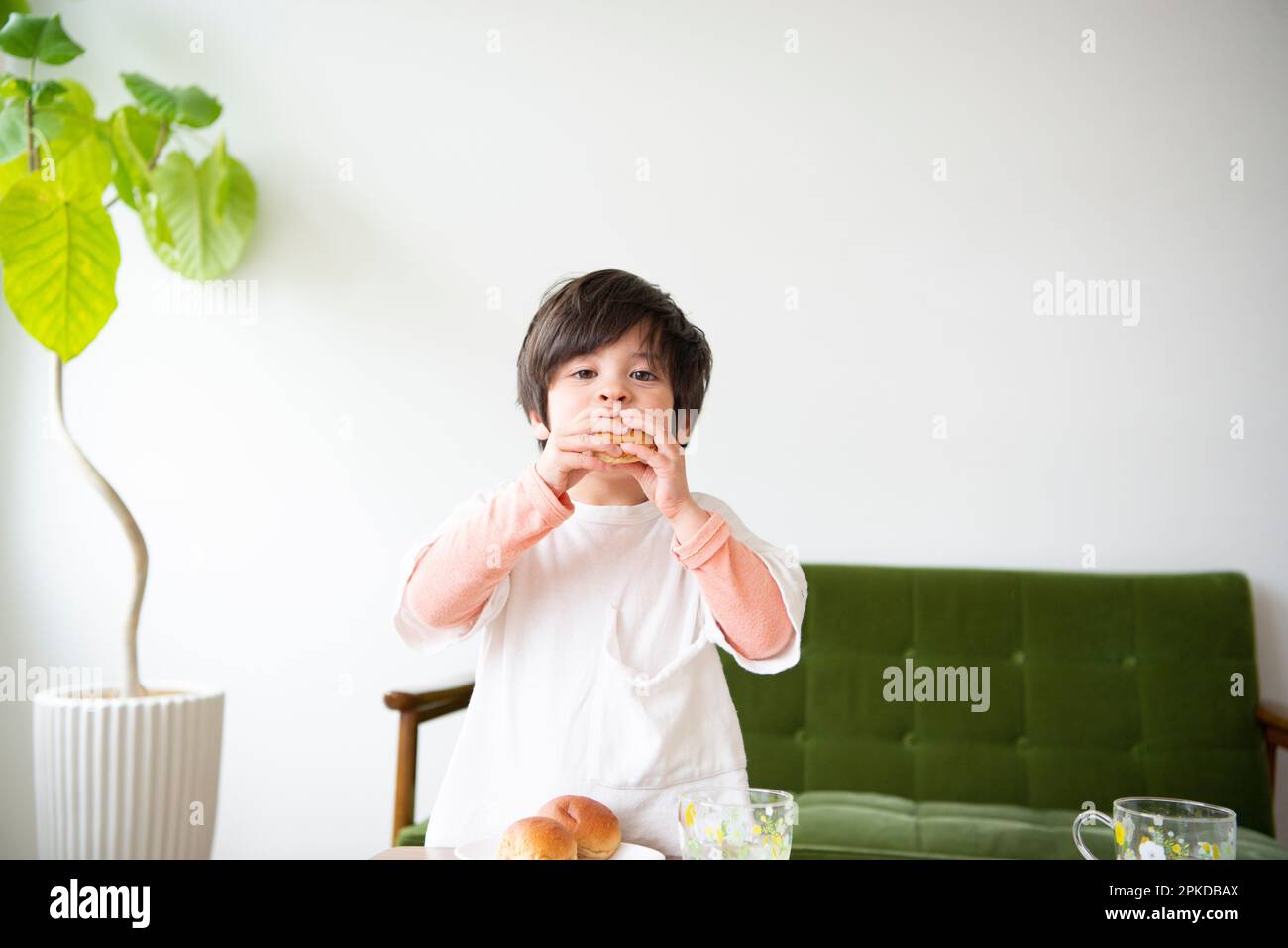 Boy eating bread Stock Photo - Alamy