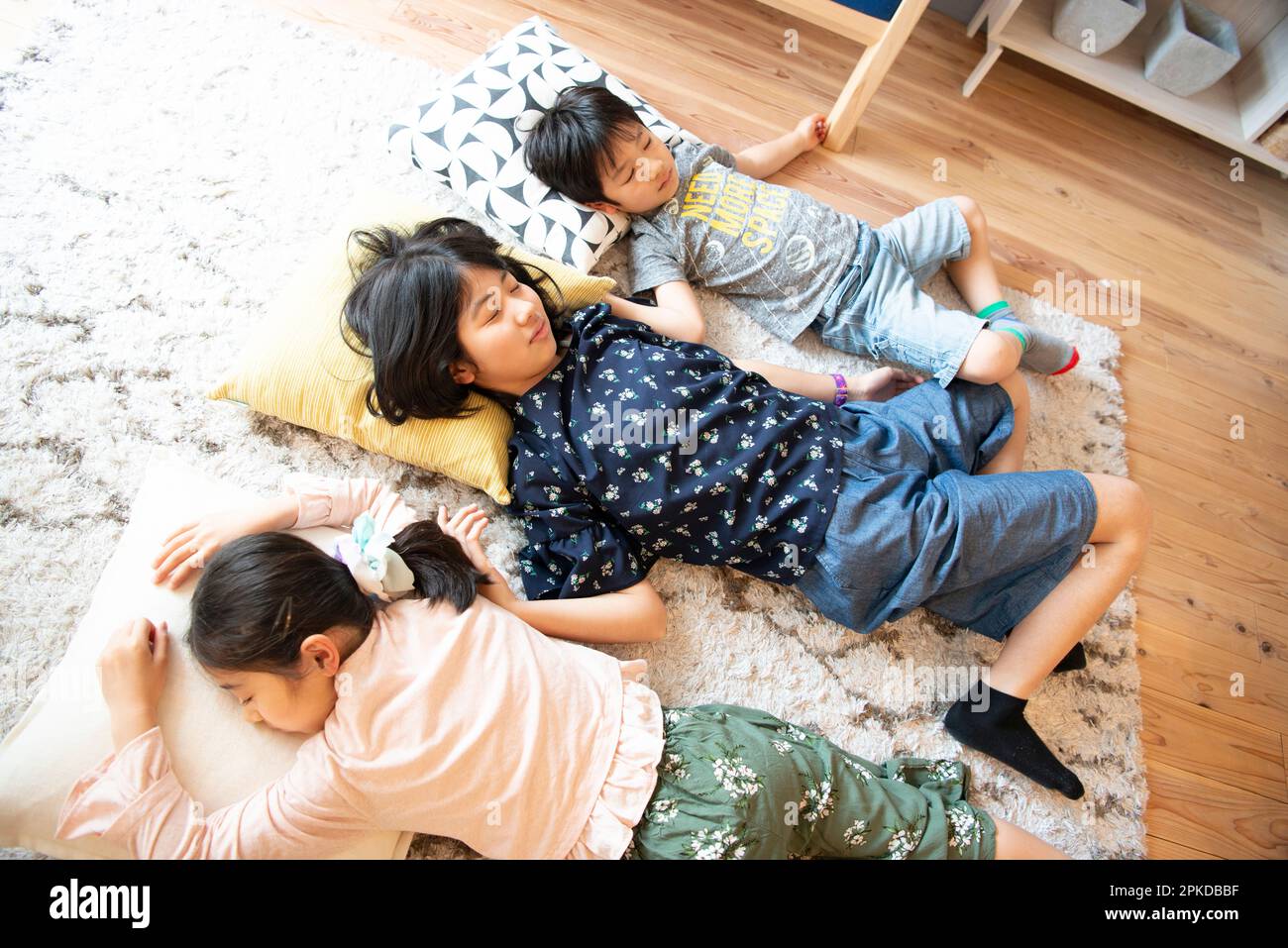 Children taking a nap in the living room Stock Photo - Alamy