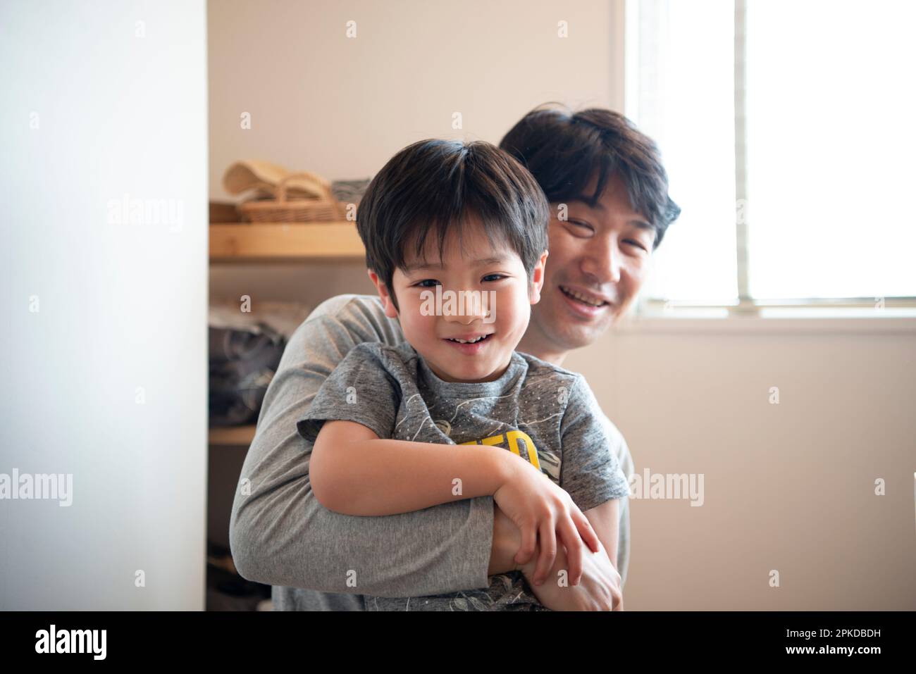 Parent and child laughing at home Stock Photo - Alamy
