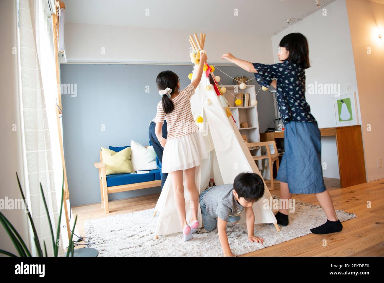 Family assembling a tent at home Stock Photo - Alamy