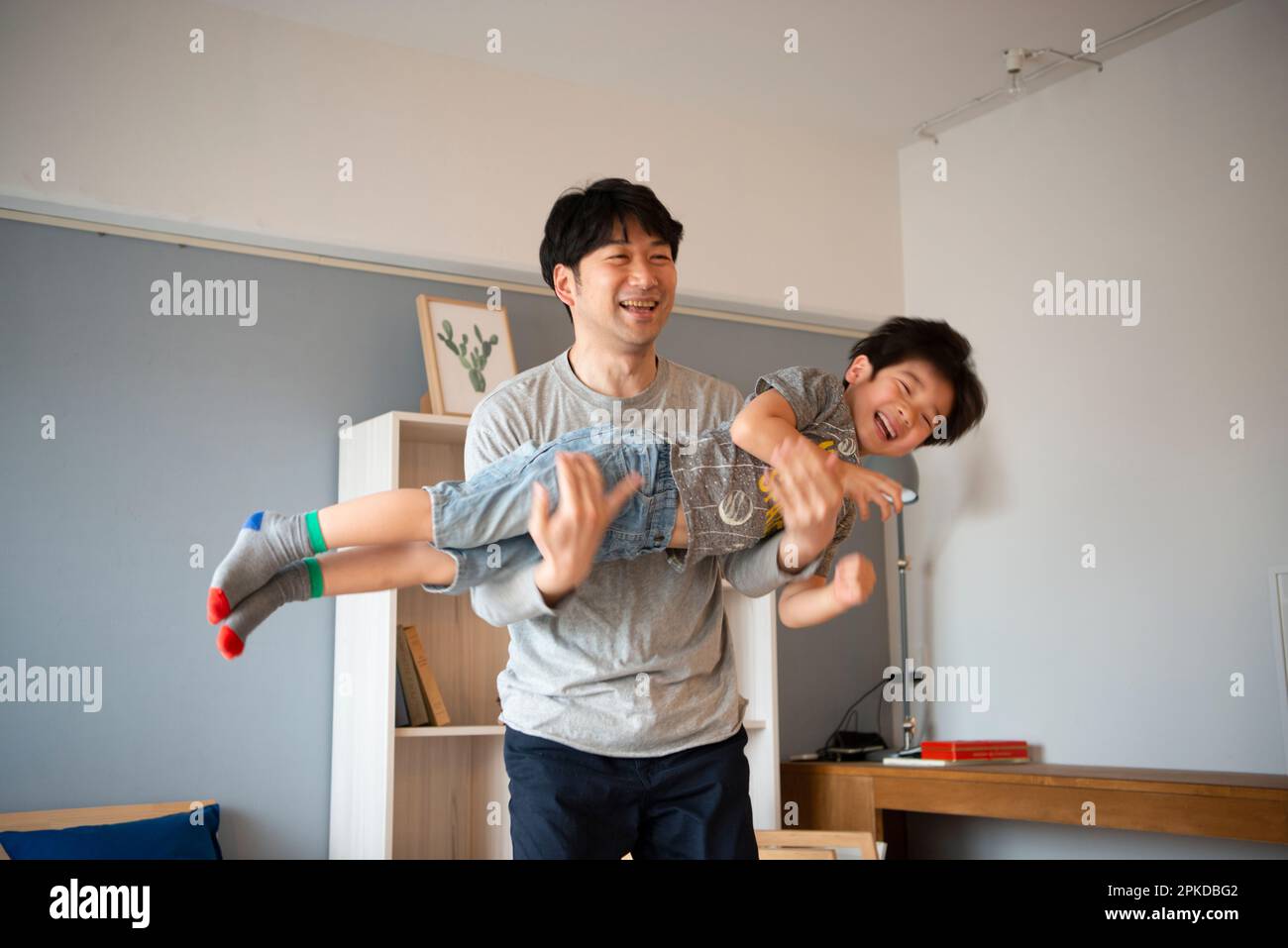 Parent and child playing in the living room Stock Photo - Alamy