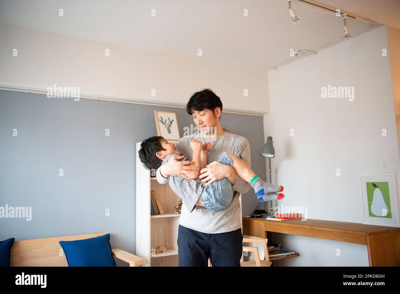 Parent and child playing in living room Stock Photo - Alamy