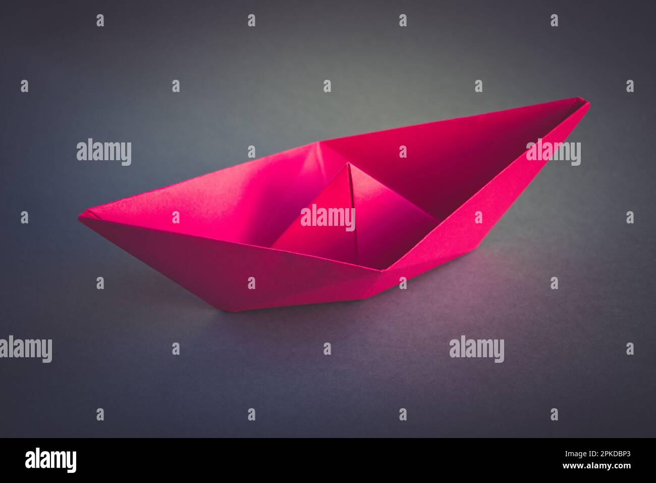 Pink paper boat origami isolated on a blank grey background Stock Photo ...