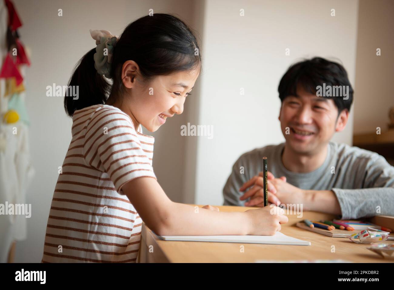 Parent and child laughing while studying Stock Photo - Alamy