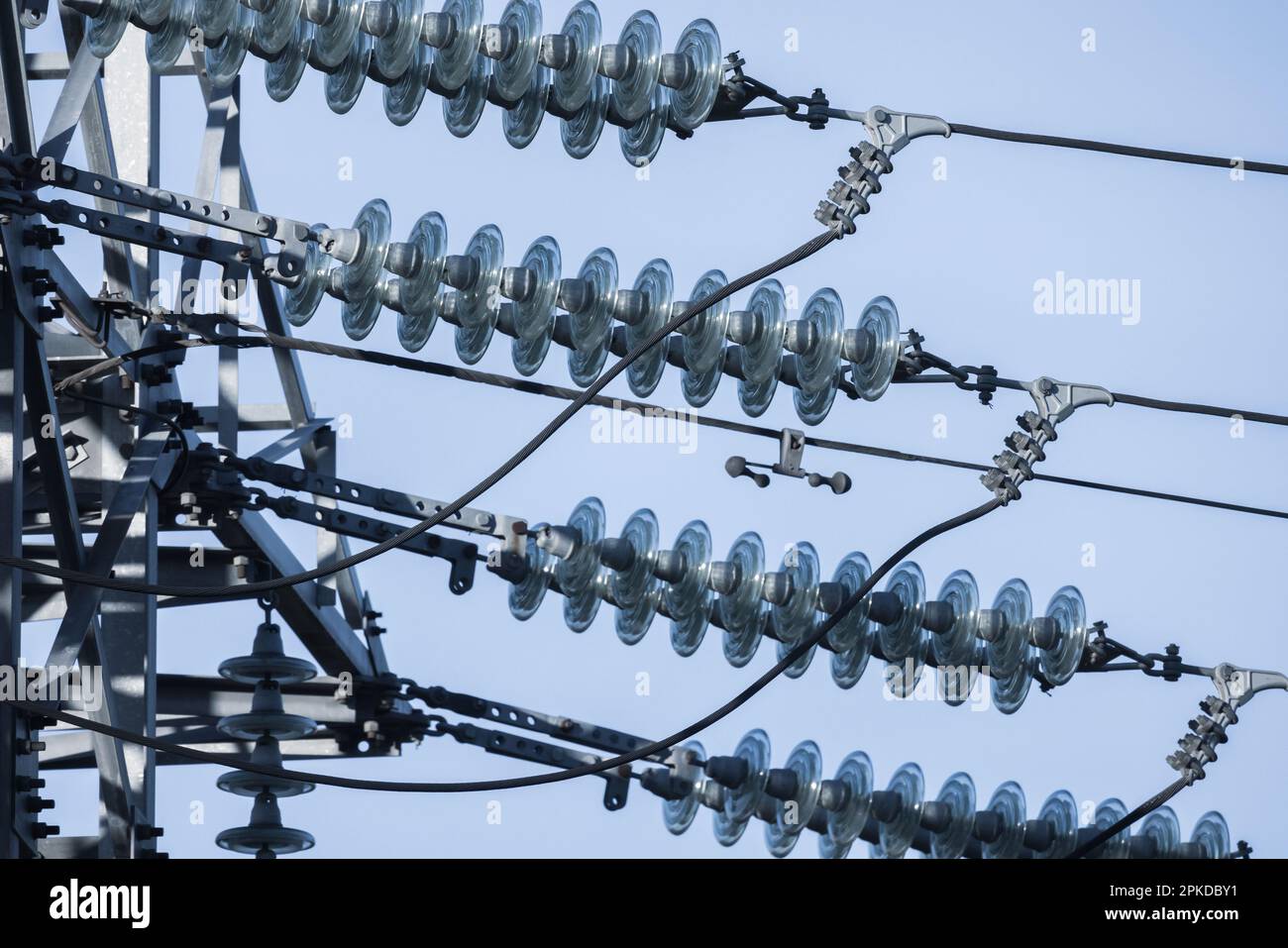 Overhead power line details are under blue sky on a daytime. High ...