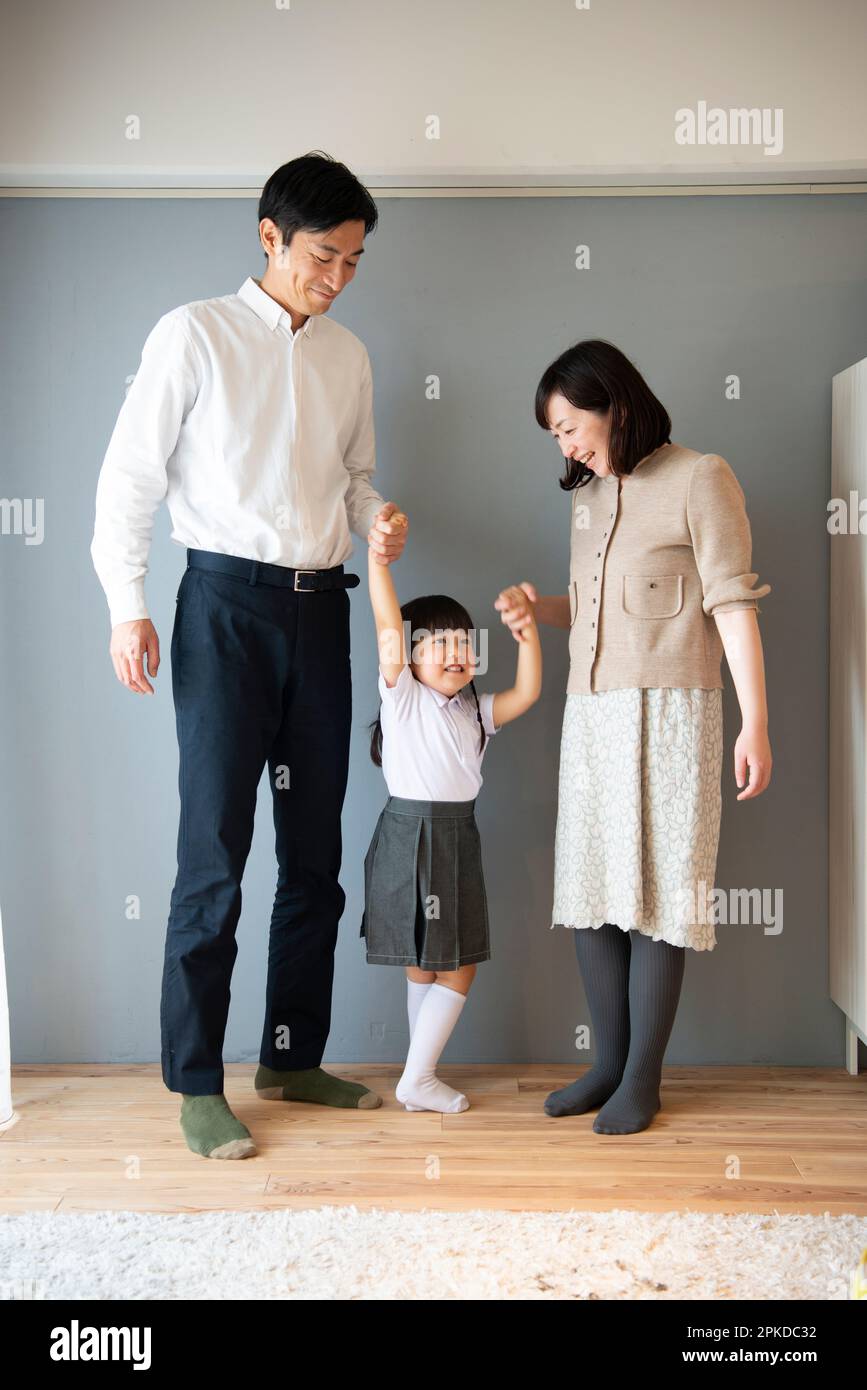 Three parents and children holding hands Stock Photo - Alamy