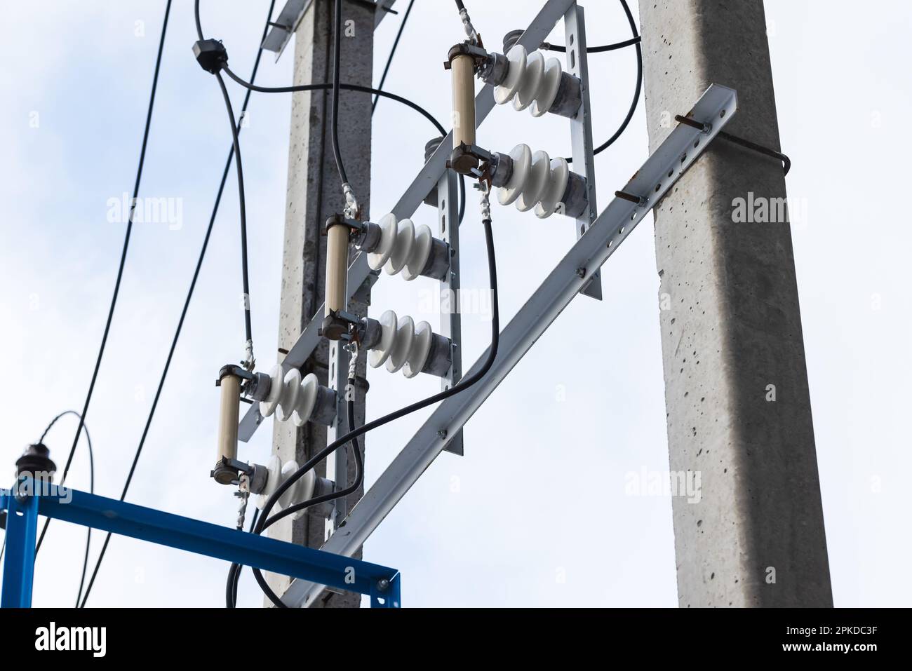 High voltage power line details mounted on a concrete pole. High ...