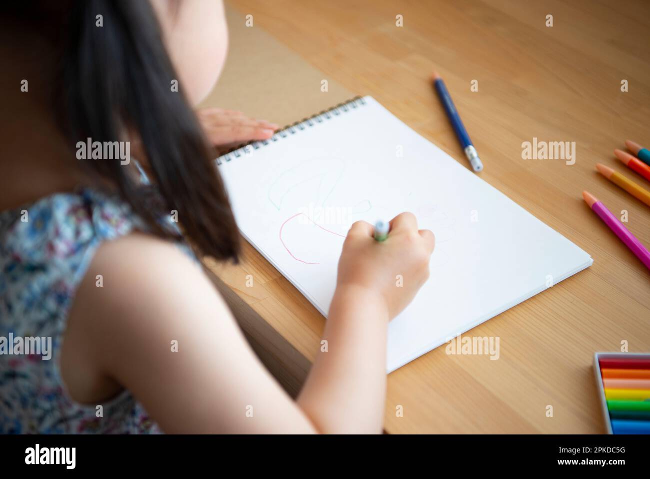 Girl drawing at desk Stock Photo - Alamy