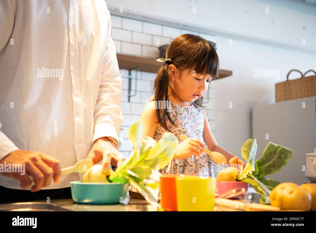Girl helping in the kitchen Stock Photo - Alamy