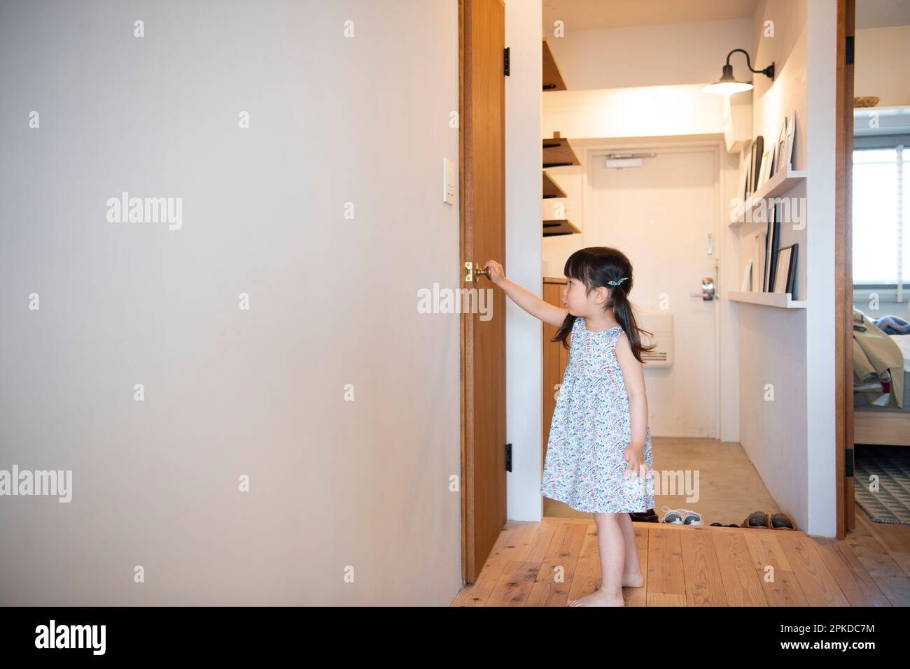 Girl closing the door Stock Photo - Alamy
