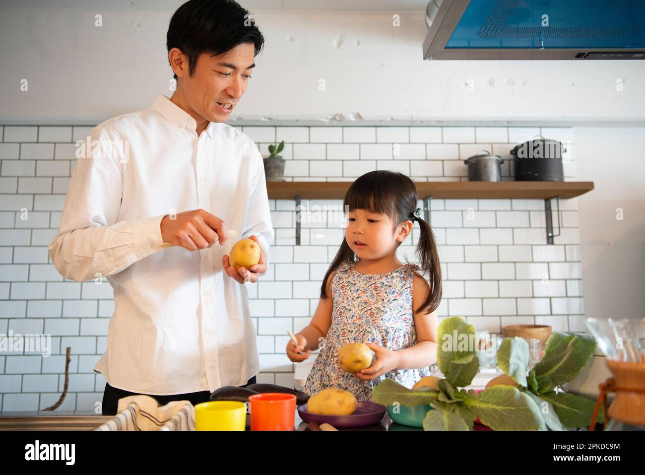 Girl and her father helping in the kitchen Stock Photo - Alamy