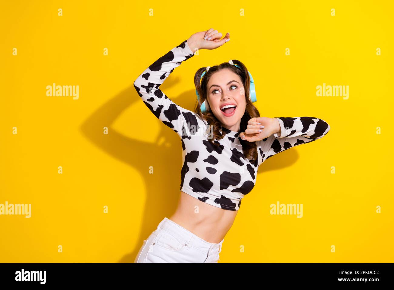 Photo of excited positive girl in black spot garment listen headset pop ...