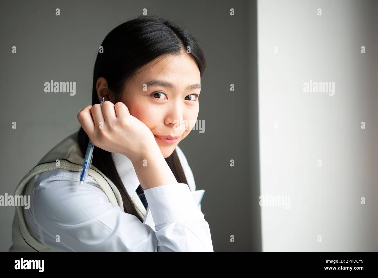 High school girl holding a mechanical pencil Stock Photo - Alamy