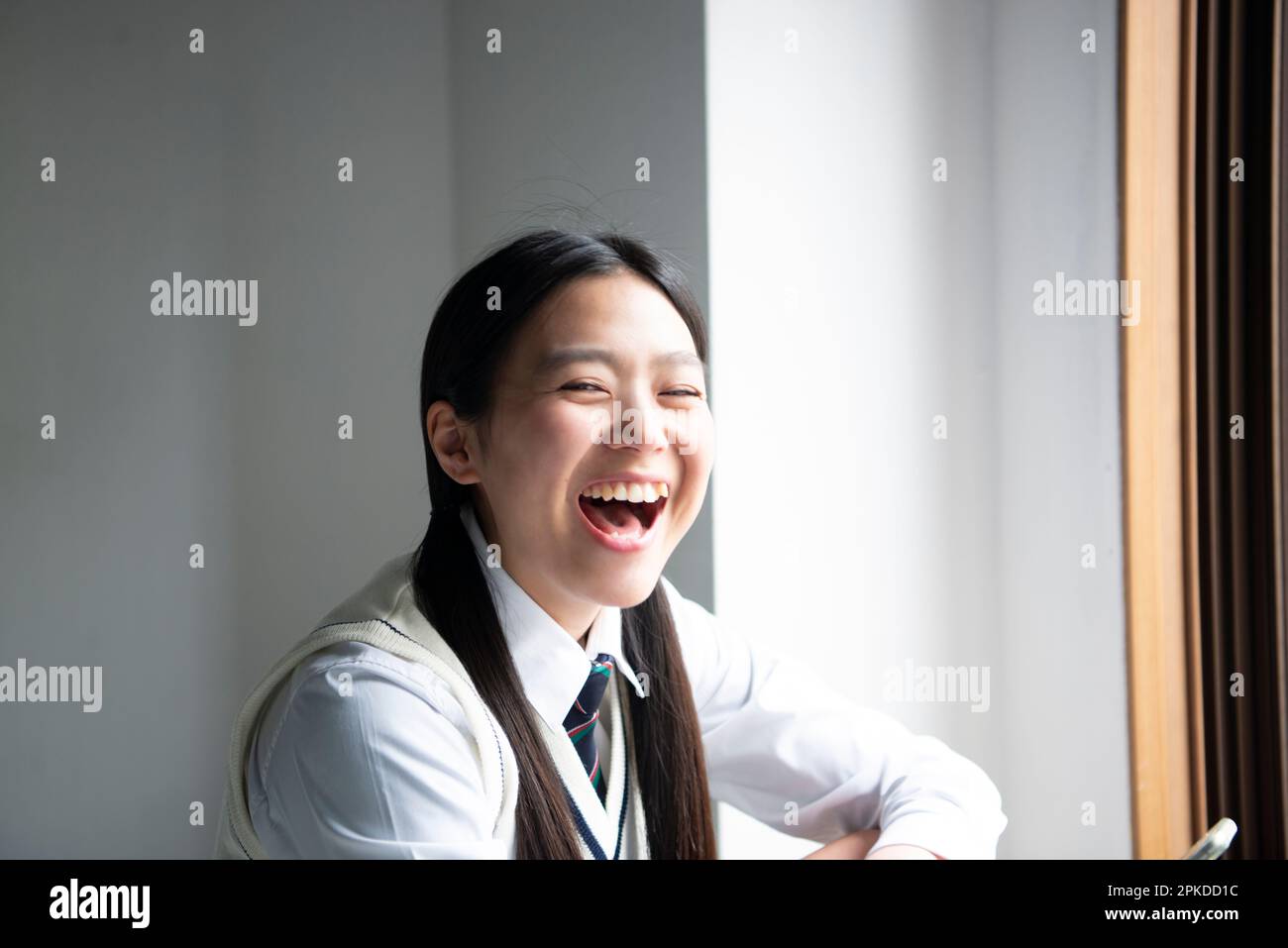 High school girl laughing hard Stock Photo - Alamy