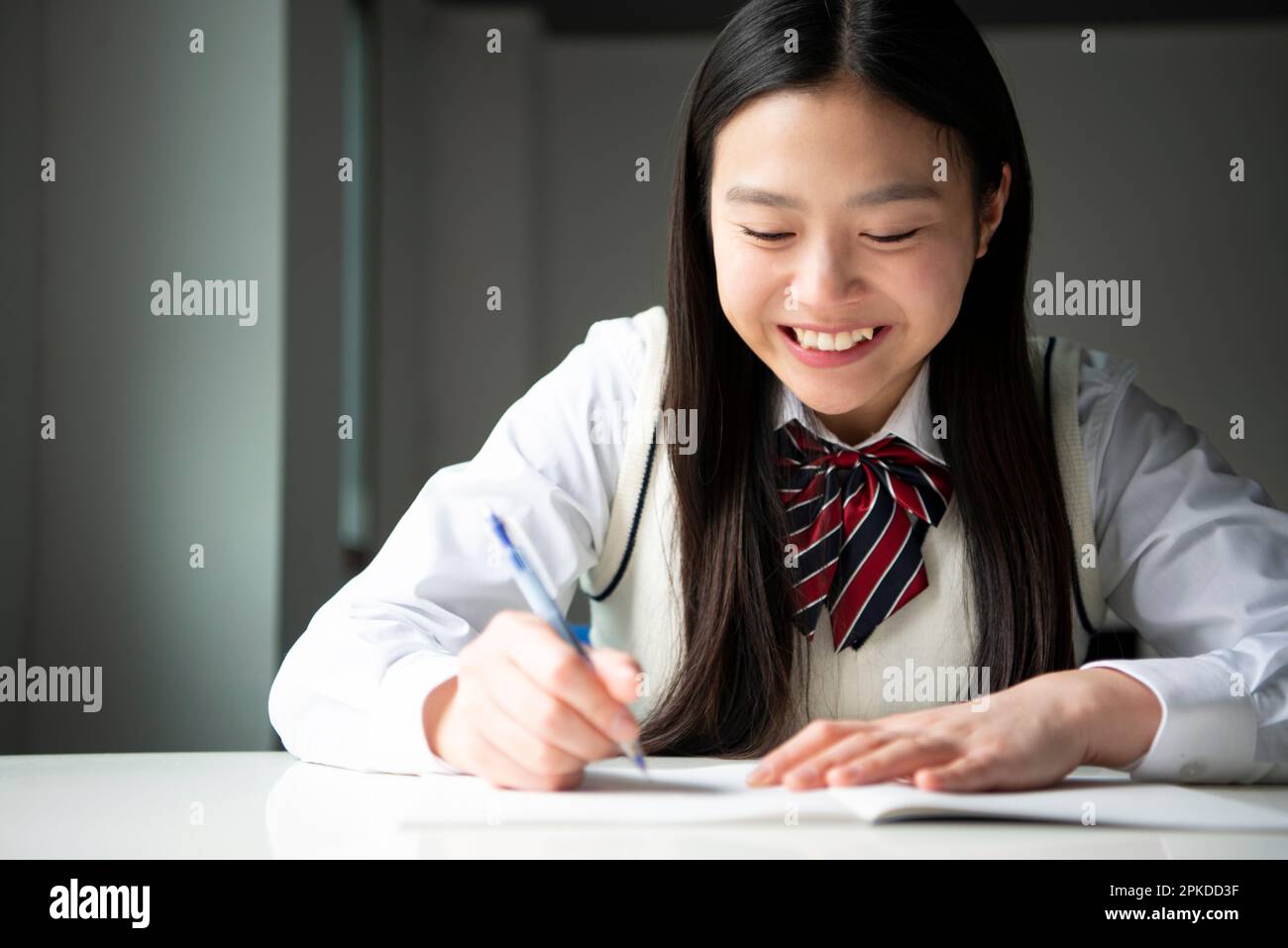 Smiling high school girl studying Stock Photo - Alamy