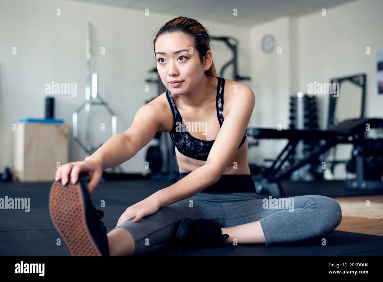 Woman stretching at the gym Stock Photo - Alamy