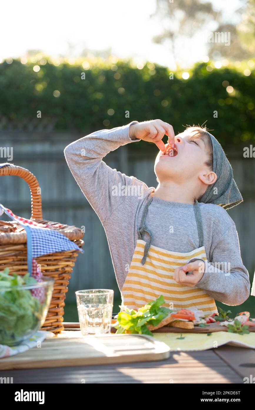 Boy cooking in garden Stock Photo - Alamy