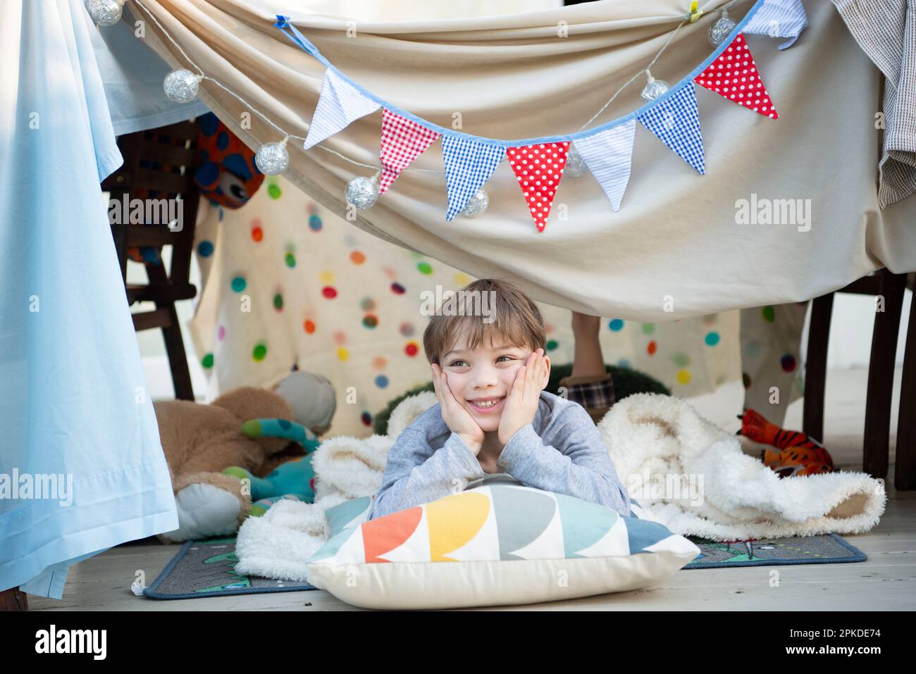 Boy inside a tent made of sheets Stock Photo - Alamy