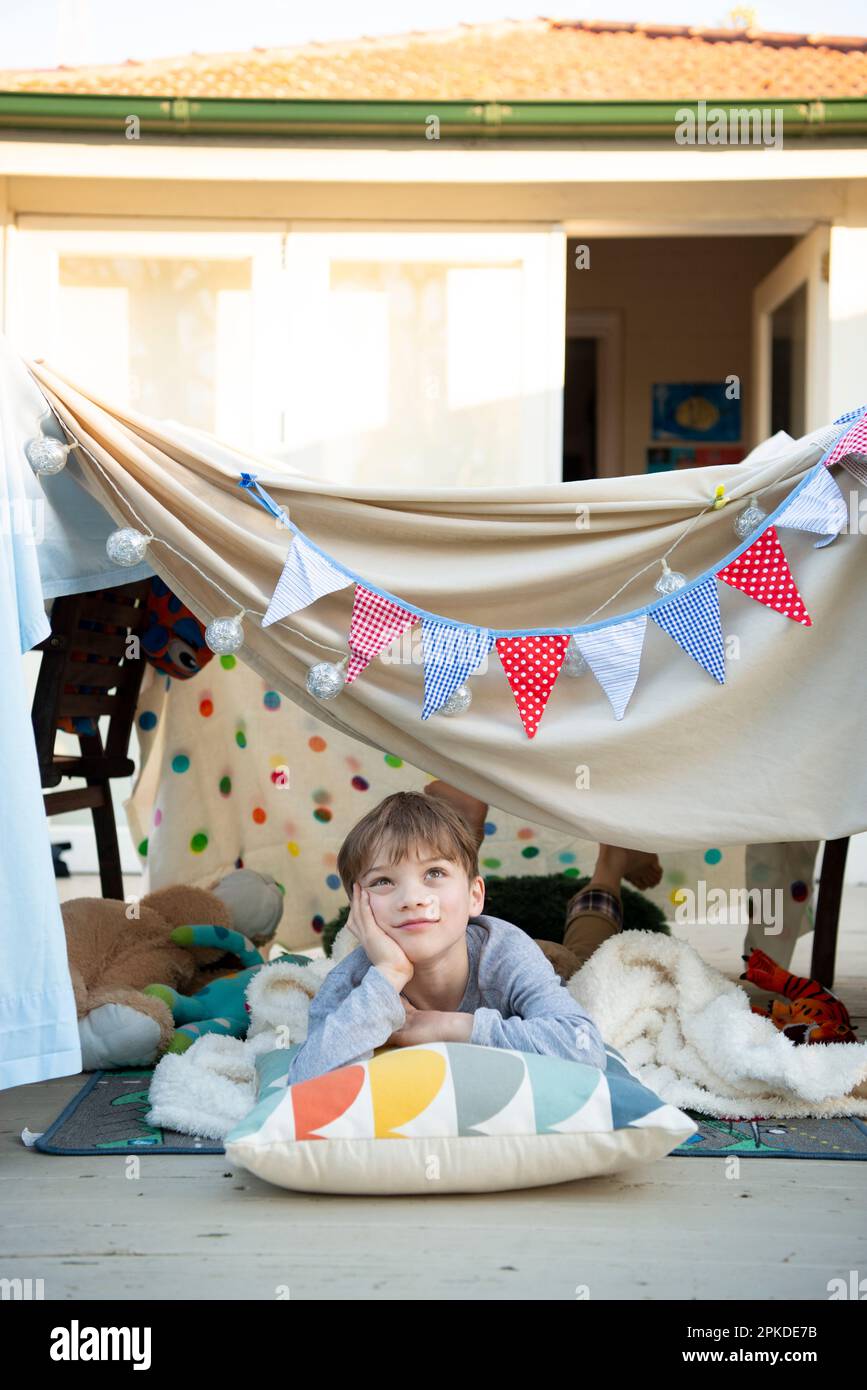 Boy in a tent made of sheets Stock Photo - Alamy