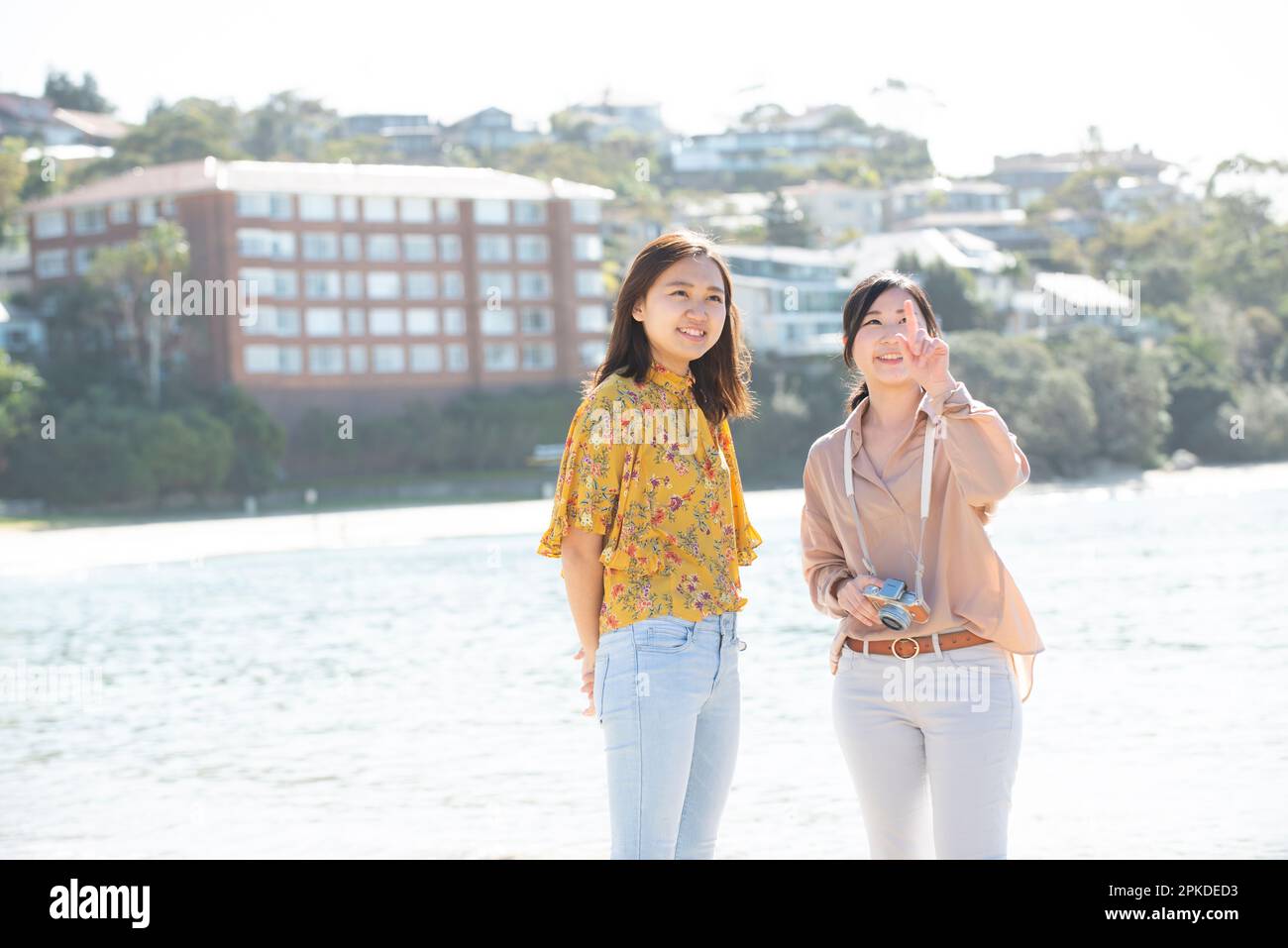 2 women laughing on the beach Stock Photo - Alamy