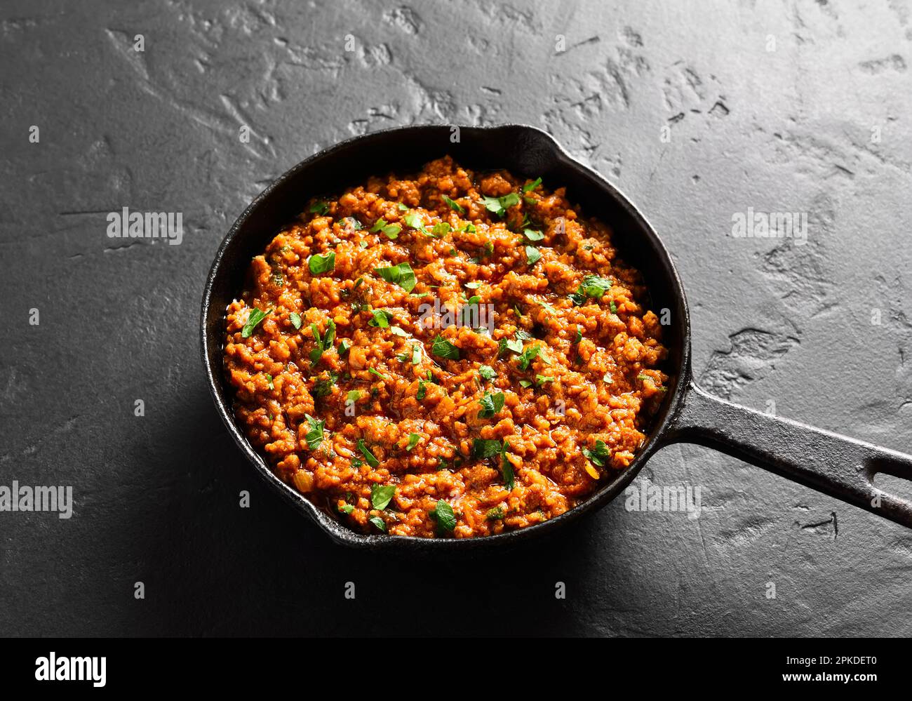 Keema curry in cast iron pan on black stone background. Indian and ...
