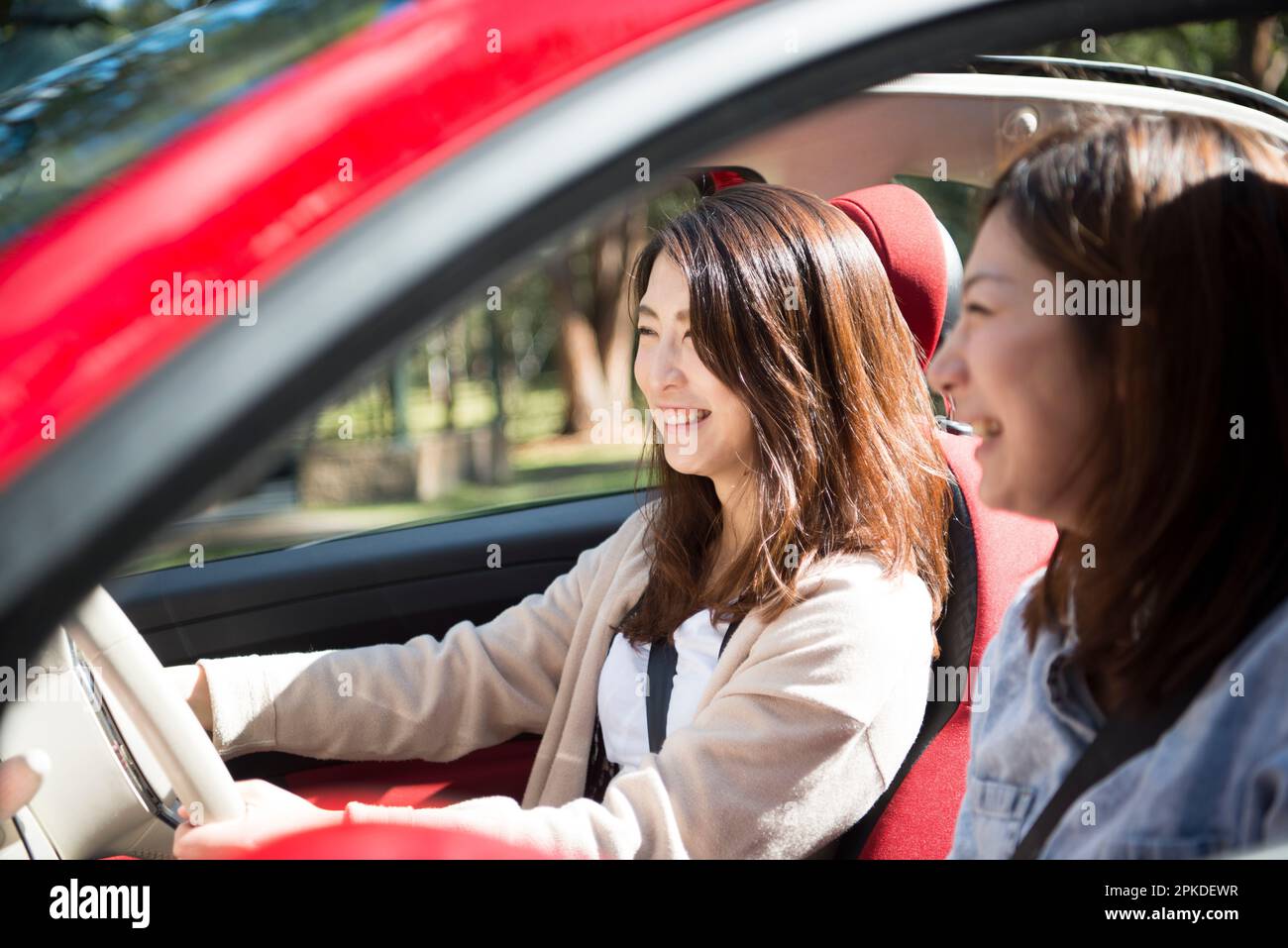 Two women enjoying a drive Stock Photo - Alamy