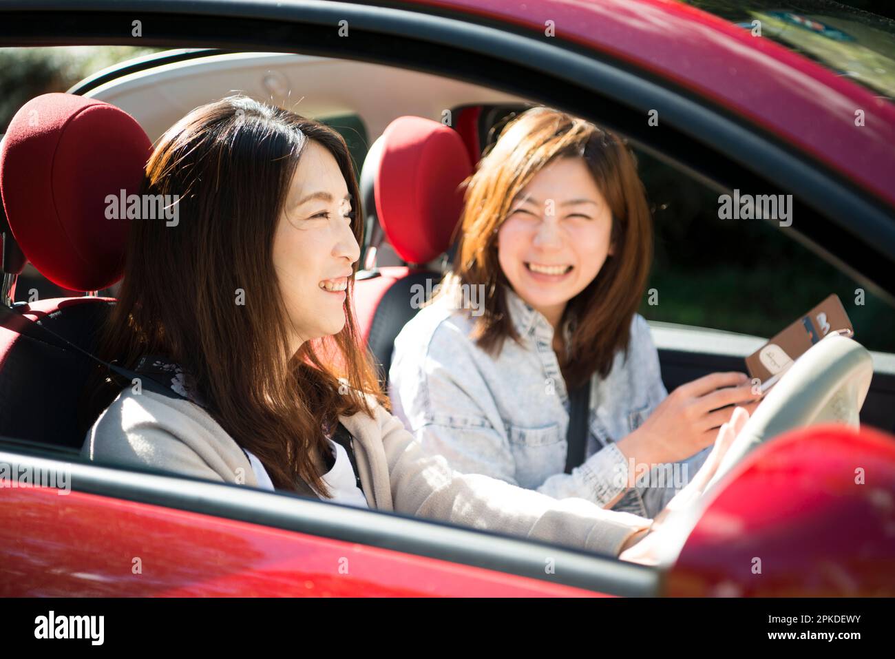 Two women enjoying a drive Stock Photo - Alamy