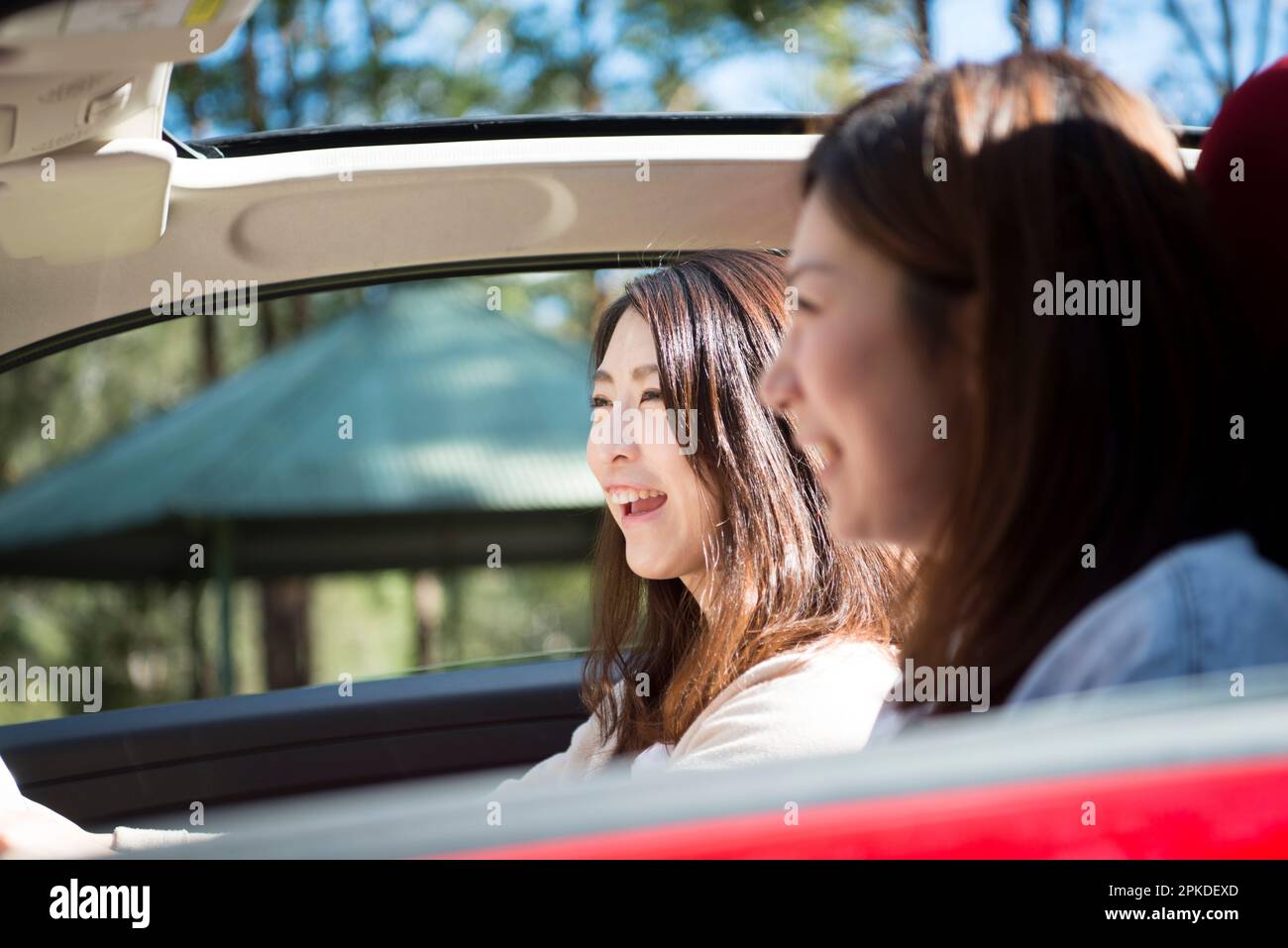 Two women enjoying a drive Stock Photo - Alamy