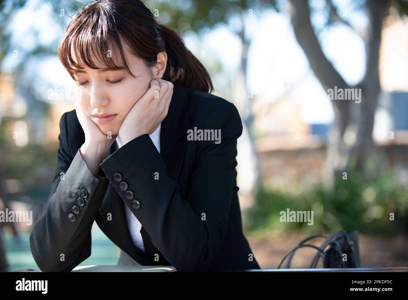 Pondering woman in a suit Stock Photo - Alamy