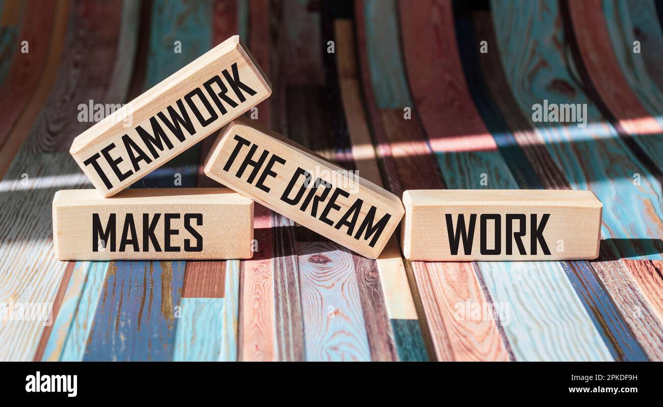 Concept words TMDW Teamwork make a dream job on a wooden block on a ...
