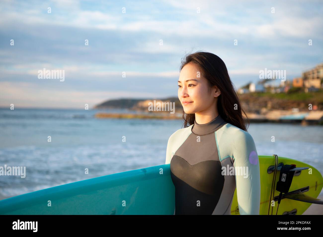 Holding her surfboard hi-res stock photography and images - Alamy