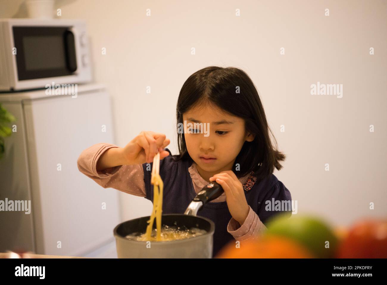 Girl cooking in the kitchen Stock Photo - Alamy