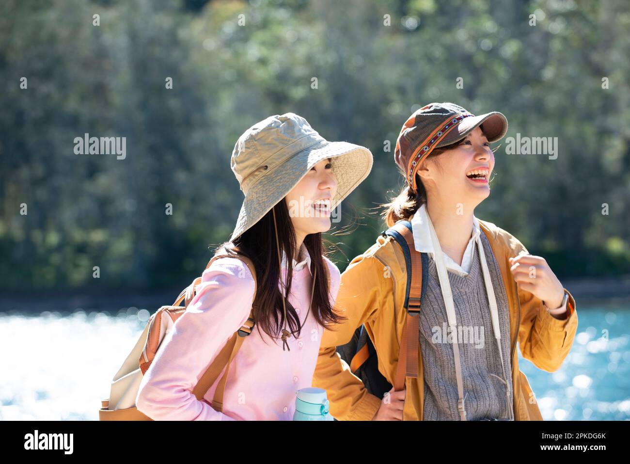 Two women laughing by the river Stock Photo - Alamy