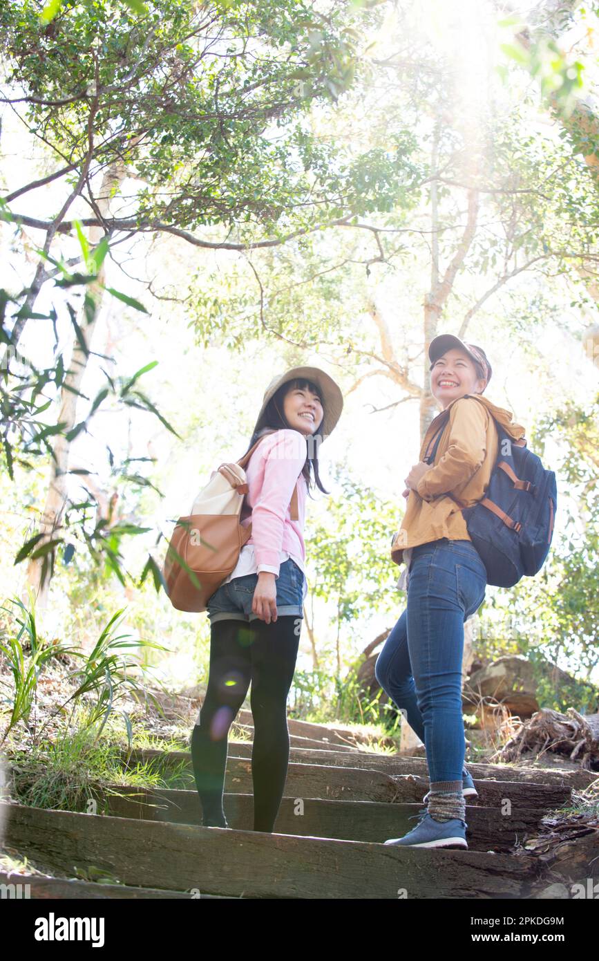 Two women hiking in the forest Stock Photo - Alamy