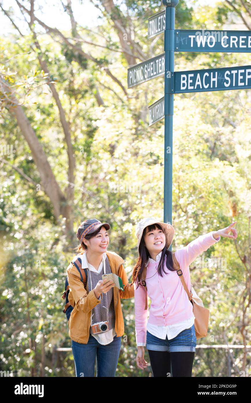 Two people checking a map on their phones while hiking Stock Photo - Alamy