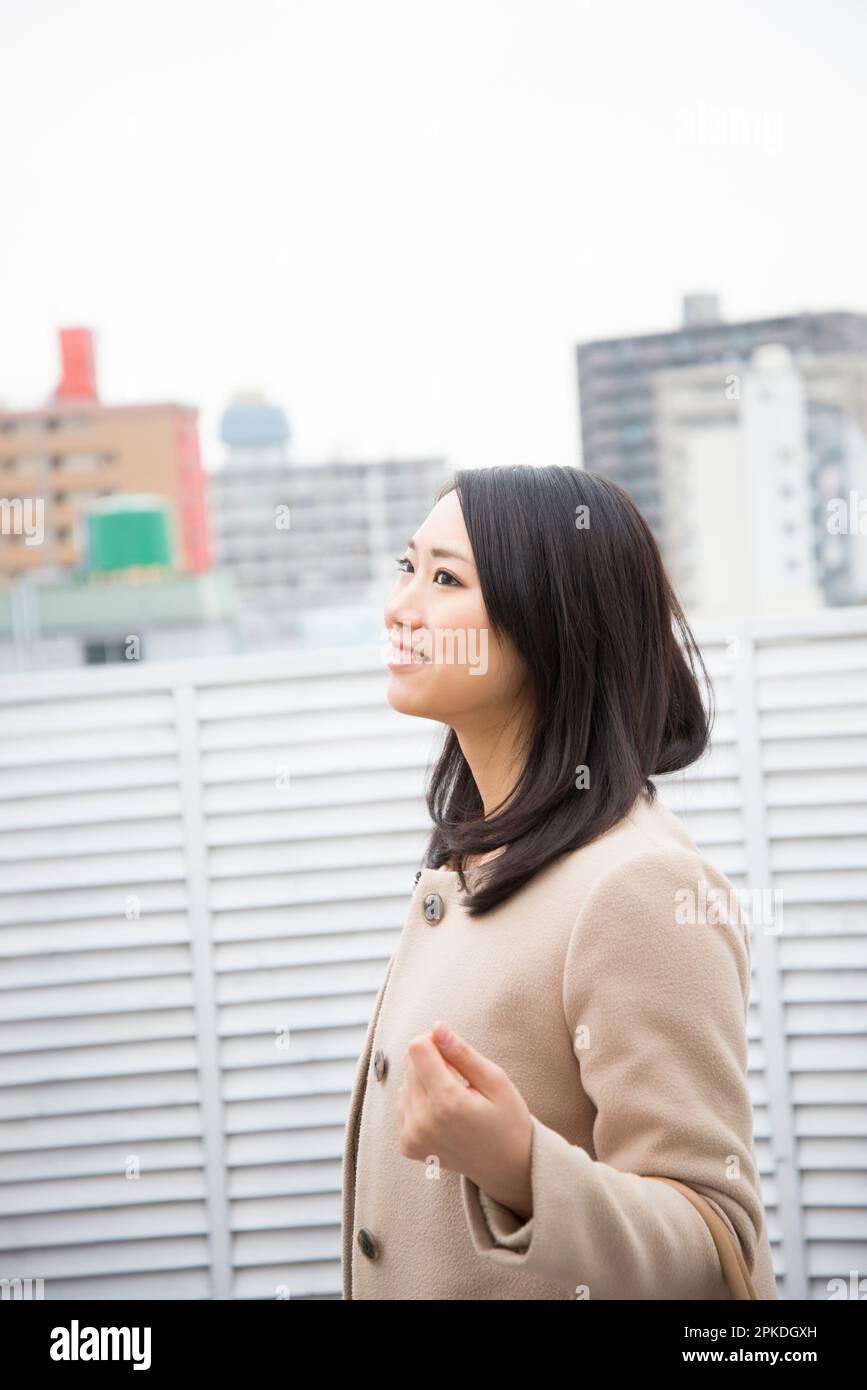 Woman walking outside Stock Photo - Alamy