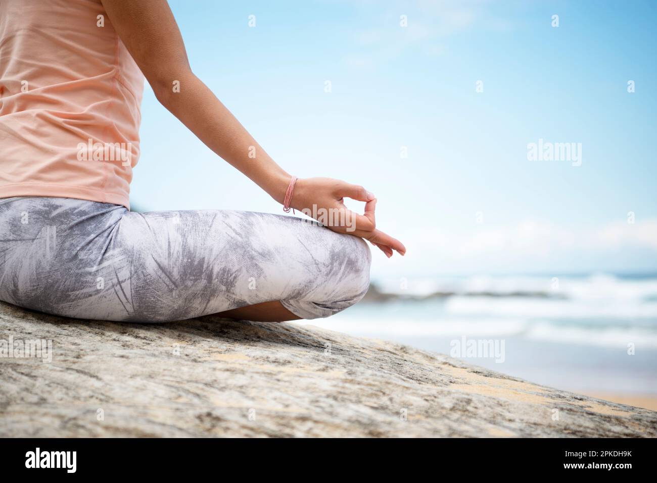 Hand of a woman meditating on the beach Stock Photo - Alamy
