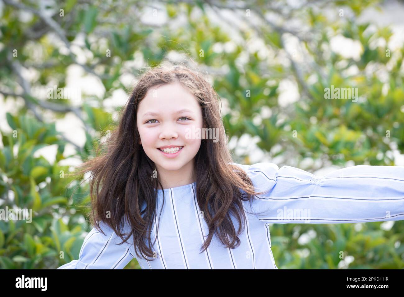 Half Girl Laughing in Front of Green Stock Photo - Alamy