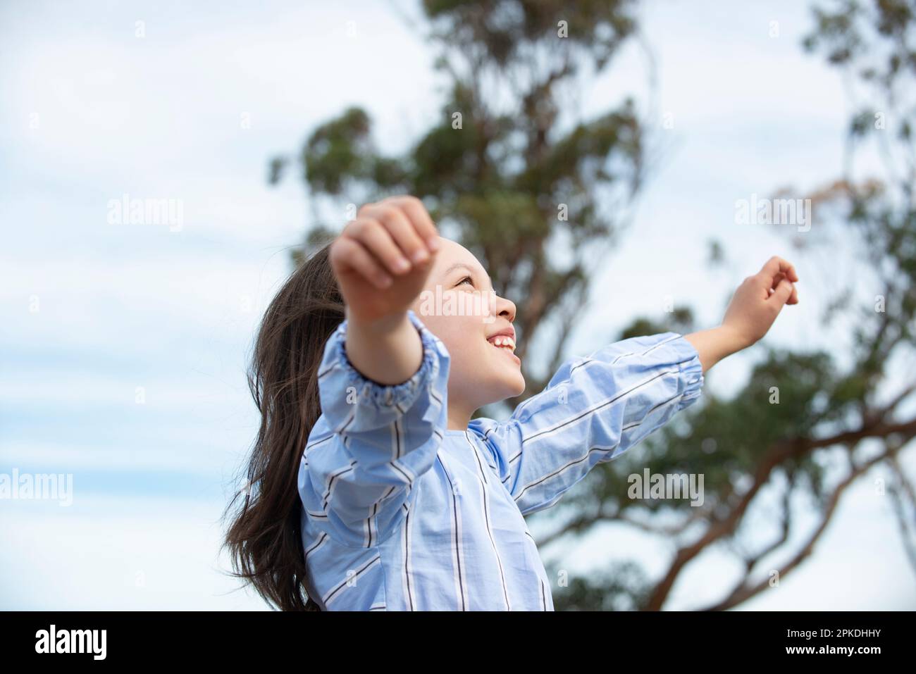 Half-girl posing in front of tree Stock Photo - Alamy
