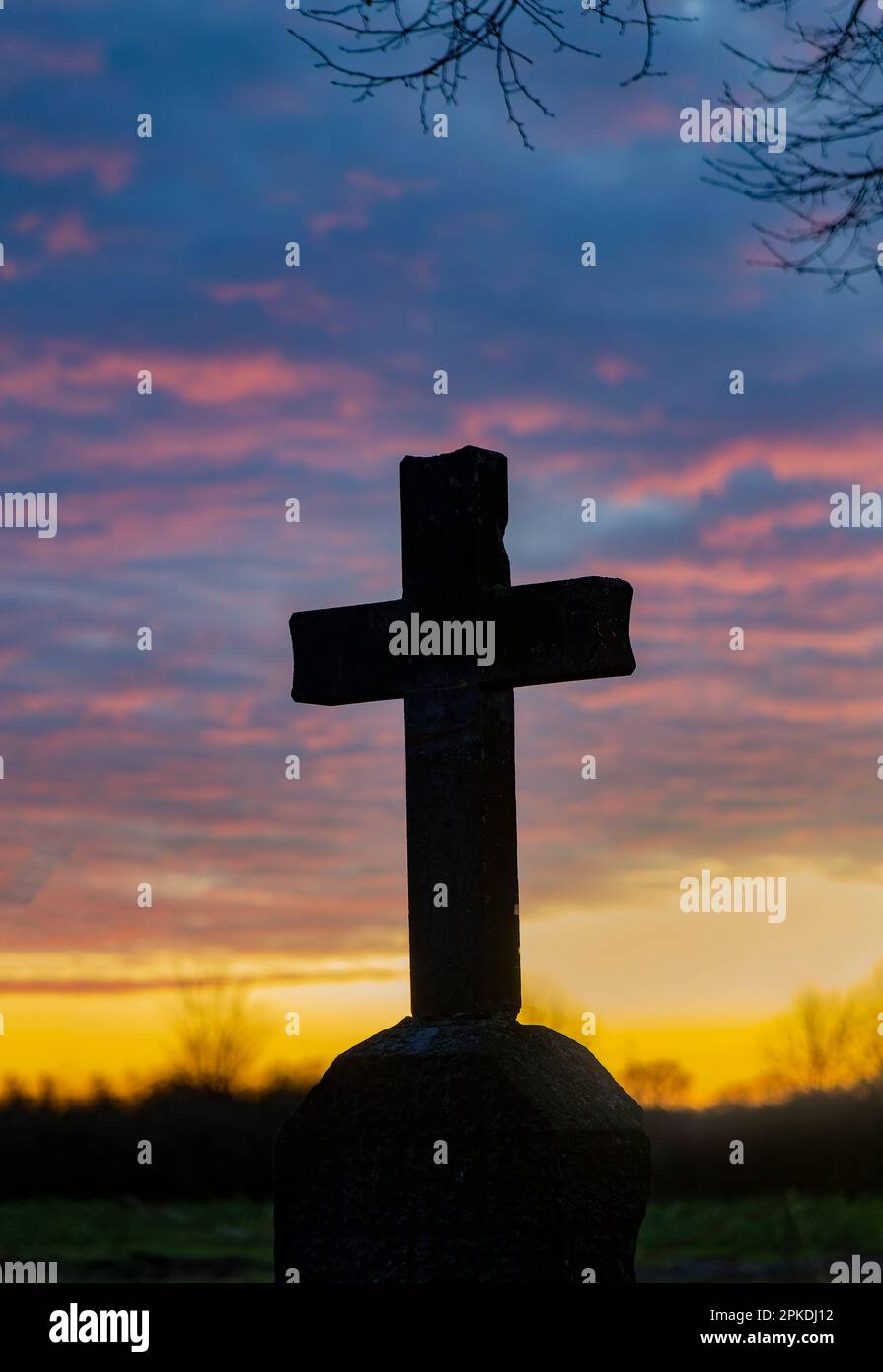 Wayside cross in front of a sunset sky Stock Photo - Alamy